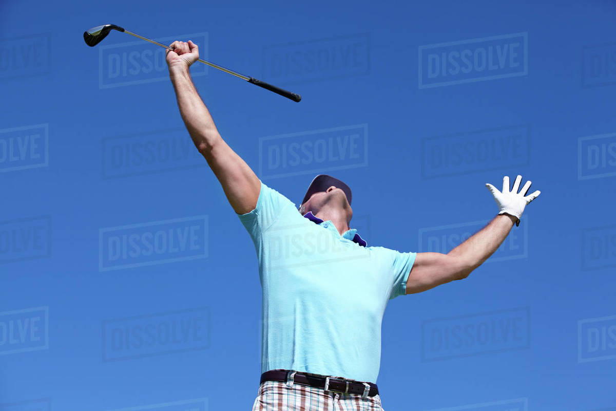 Golf, winner and man with hands up in celebration on blue sky ...