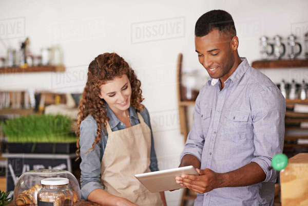 Cafe owner, tablet and teamwork of people, discussion and training in ...