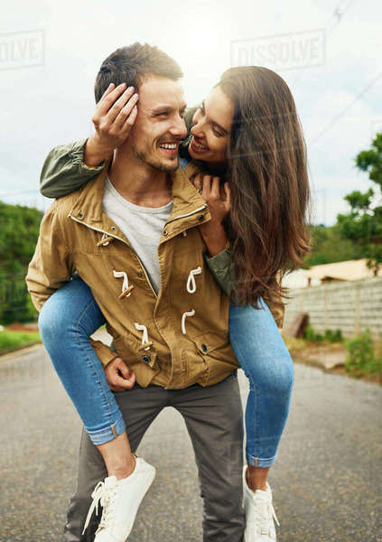 Care, love and piggyback with couple in road for happy, smile and ...