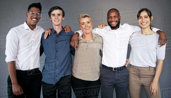 Group portrait, business people and hug by wall with teamwork, smile or ...