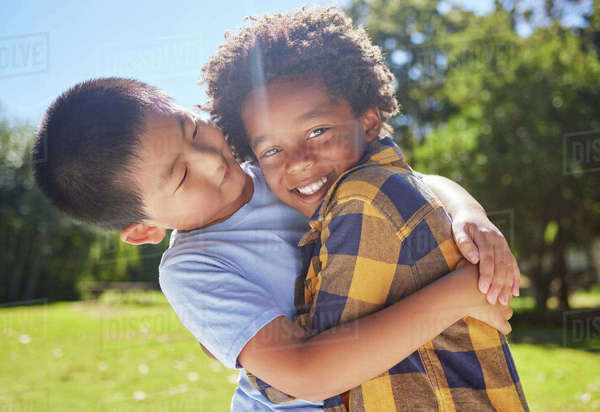 Happy, children or friends hugging in park together for fun, bonding or ...