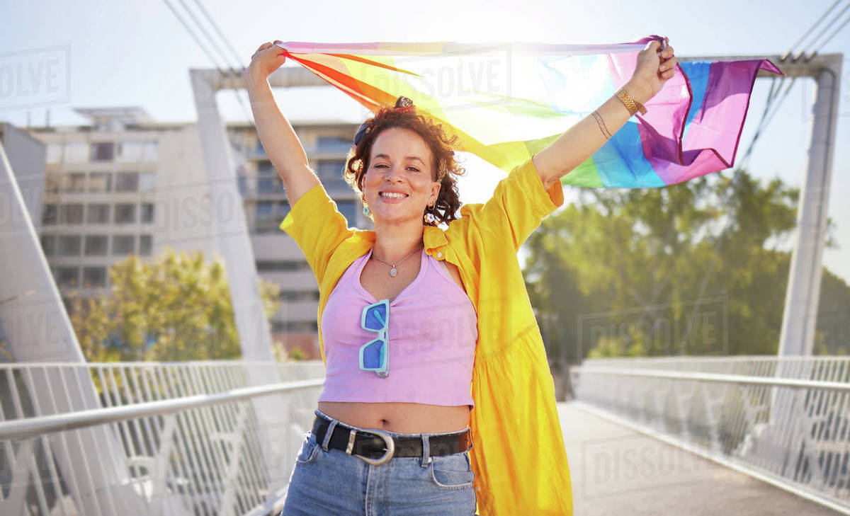 Portrait, pride and lesbian woman with flag on city bridge, lgbtq ...