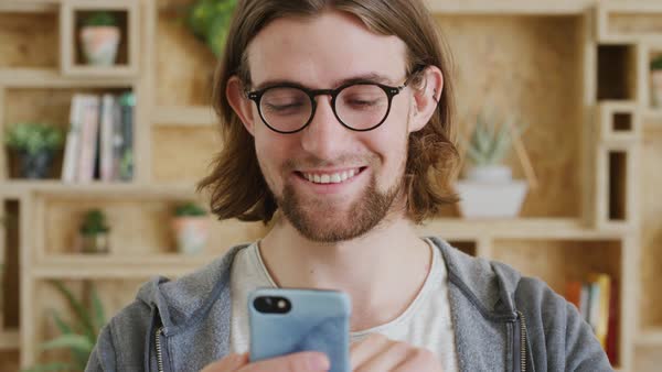 Phone, social media and communication with a man nerd typing a text ...