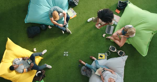 Diverse group of modern technology students using fun room to boost ...