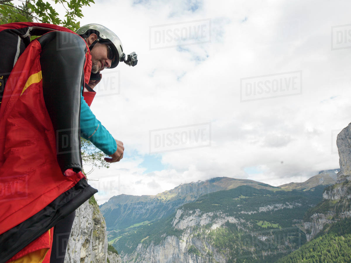 Wingsuit flyer preparing to jump - Stock Photo - Dissolve