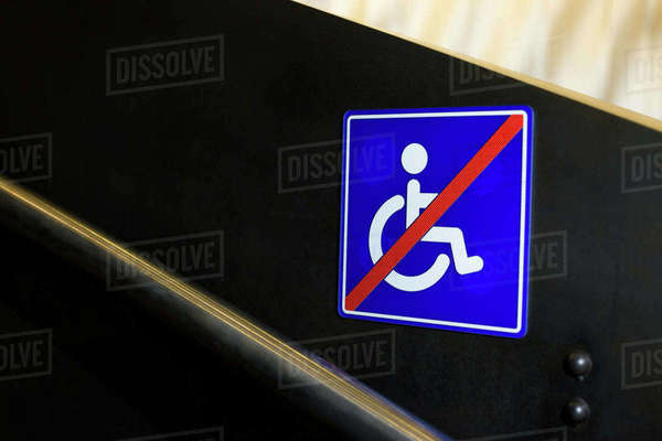 Blue square sign No disabled people on wheelchair. Sign on the wall ...