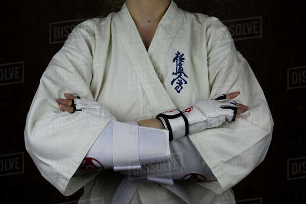 Girl in kimono and protective equipment for Kyokushinkai karate crossed ...