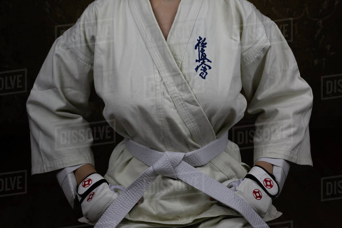 Young woman in kimono in Kyokushinkai karate sits in traditional ...