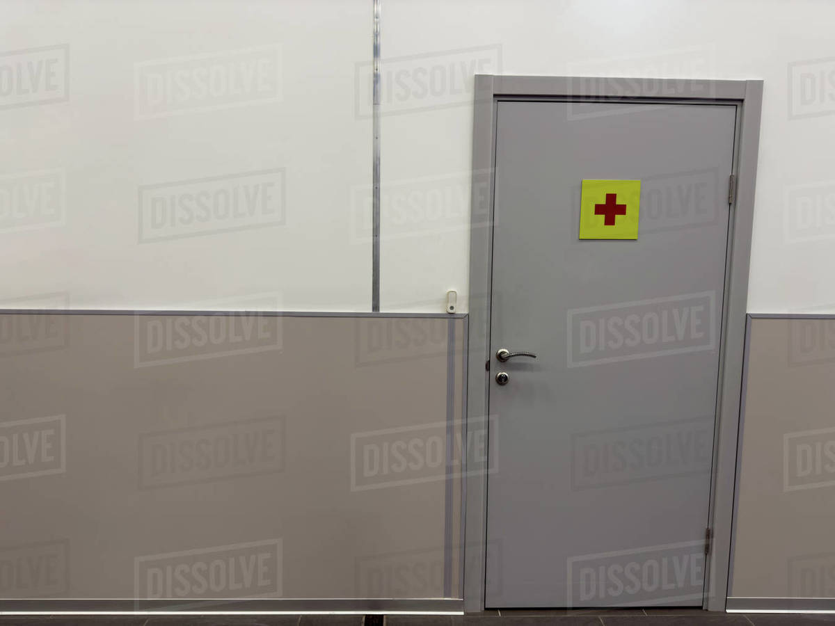 Entrance door to medical office in public place. Medical aid station ...