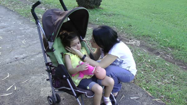 Mother comforting crying baby girl in stroller - Stock Video Footage ...