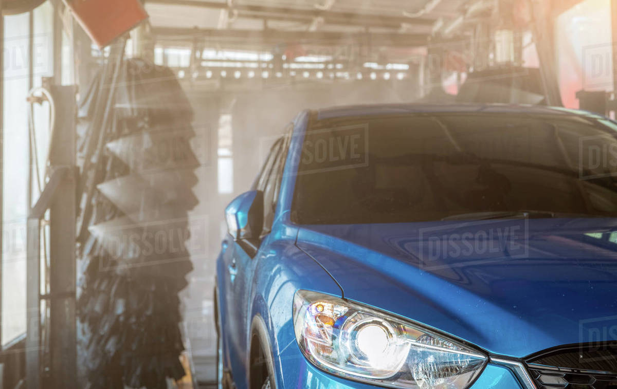 Blue SUV car washing by automatic car washing machine. Auto care. Car ...