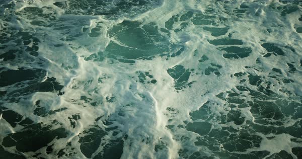Boiling ocean waves foam water background at storm. Top down raging sea ...