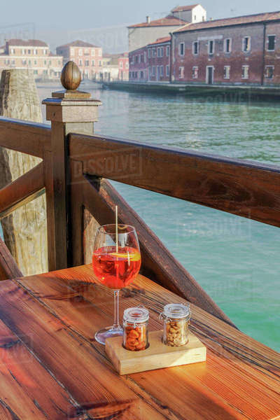 Aperol Spritz orange alcoholic cocktail, with olive on a toothpick and ...