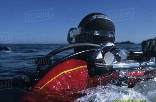 Scuba diver with twin tanks on surface, Anacapa Island, Channel Islands ...