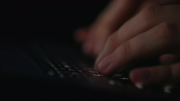 Close up of caucasian male hacker typing on keyboard of modern laptop ...