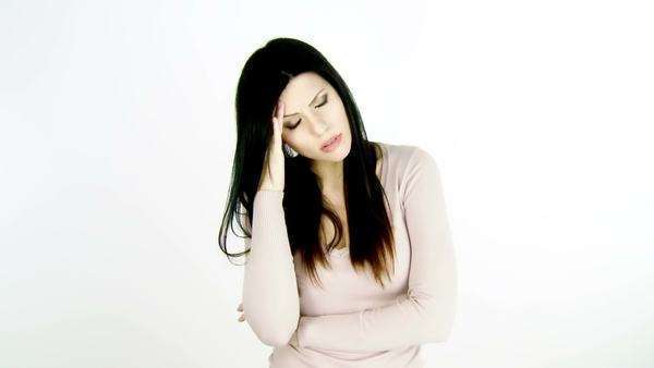 Sad woman feeling sick because of headache - Stock Video Footage - Dissolve