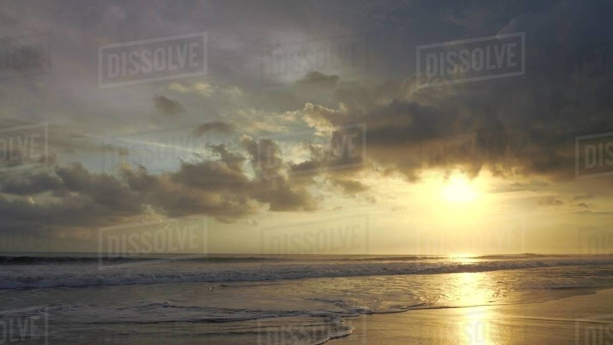 A beautiful golden yellow and dark grey stormy sunset. Bright sun ...