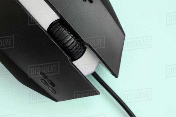 Closeup of a black gaming optical mouse on a blue background. Device ...