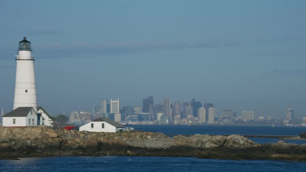 Aerial view of Boston city skyscrapers and Boston Light a lighthouse on ...