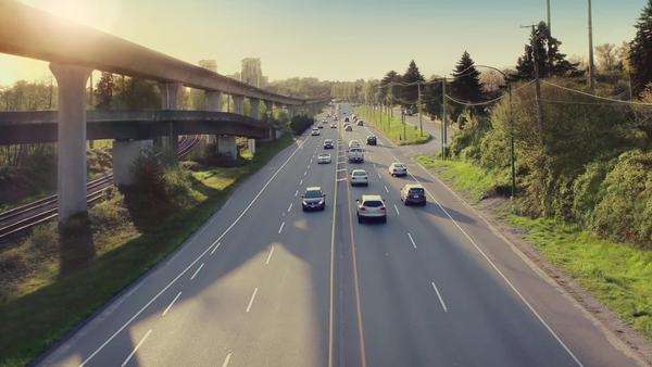 Overhead shot of cars, a bus and a tanker truck on a major road near ...