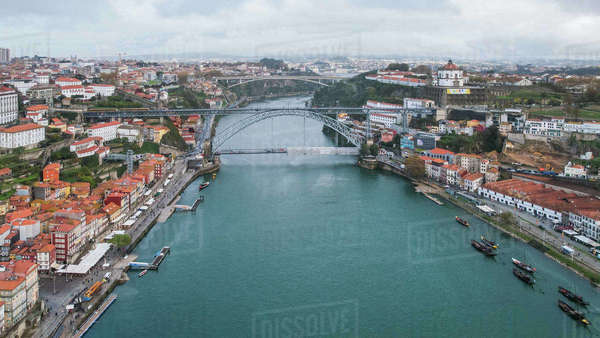 Aerial flying backwards over Douro River revealing Luis I Bridge. Porto ...