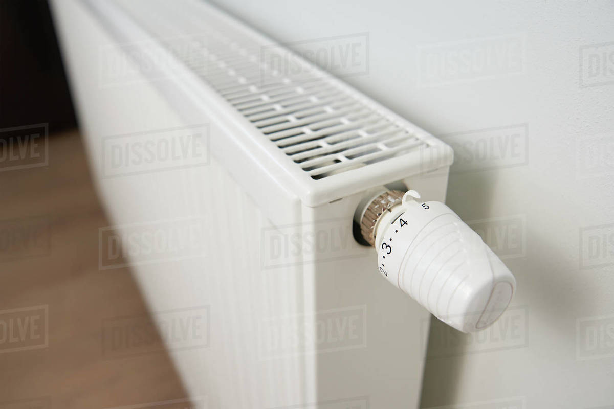 Adjusting temperature on heating radiator thermostat, Turning heat ...