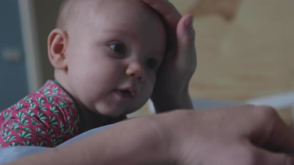 Face of enthusiastic baby at play on parent's stomach. Closeup. - 4K ...