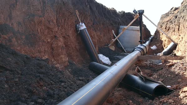 A trench with a gas pipeline, polypropylene pipe, installation of a tie ...
