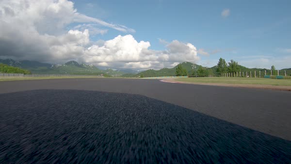 Racing on a closed asphalt racetrack during a track meet on a sunny day ...