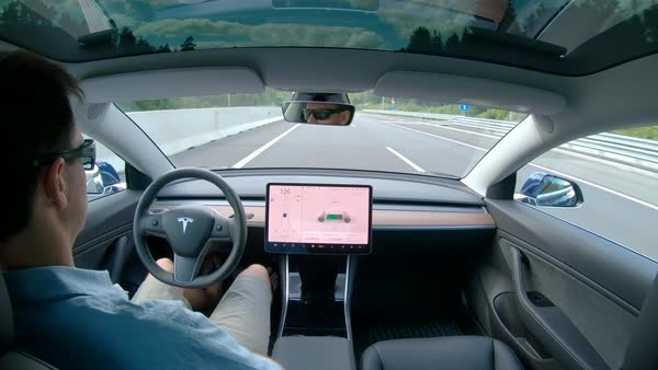 TESLA AUTONOMOUS ELECTRIC CAR, MAY 2019: CLOSE UP Confident man does ...