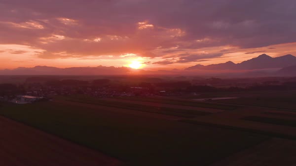 AERIAL: Flying over fields of wheat and away from rural town on a ...