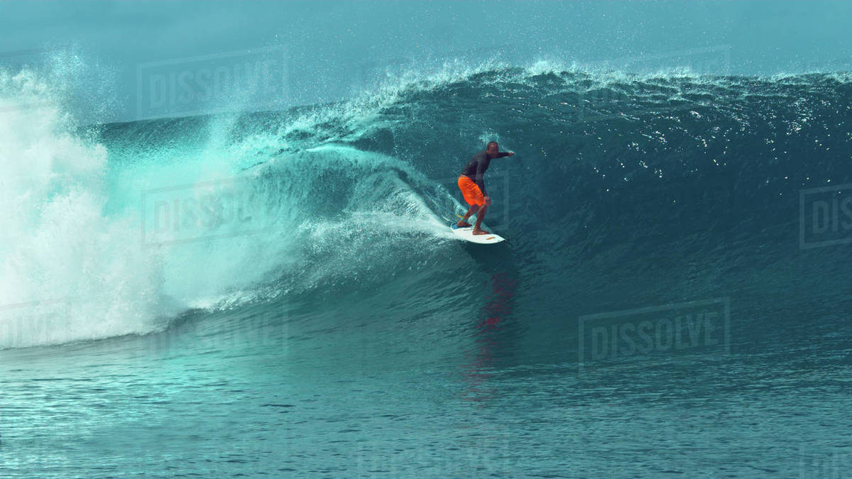 CLOSE UP: Fearless young pro surfboarder rides a glassy emerald ocean ...