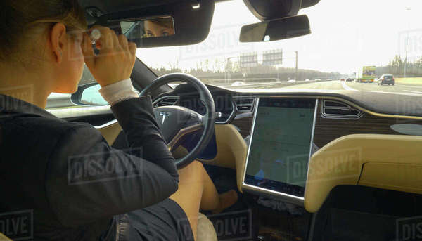 AUTONOMOUS TESLA CAR, MARCH 2018 - CLOSE UP: Businesswoman commutes in ...