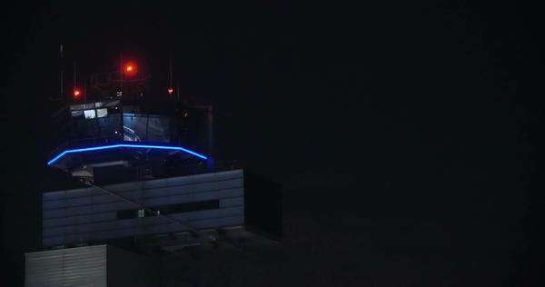 Night view of control tower at the airport. Red light on and white ...