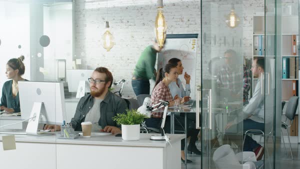 Timelapse of a busy creative office. Office people working at their ...