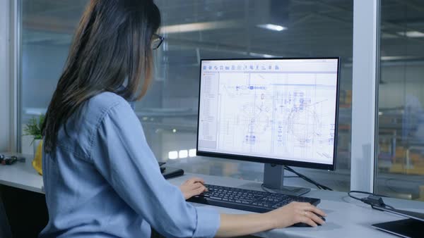 Female industrial engineer working with technical blueprints on her ...