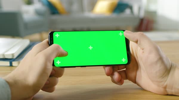 First person close-up of the man holding green screen smartphone in ...