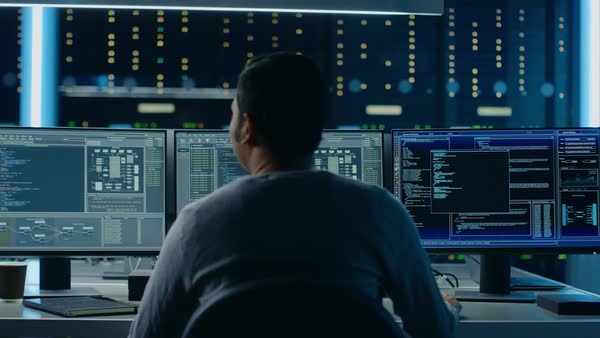 IT Specialist Takes His Place at the Desk and Starts Working on ...