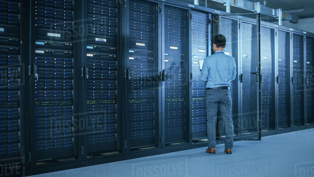 In Data Center: Male IT Technician Running Maintenance Program on a ...