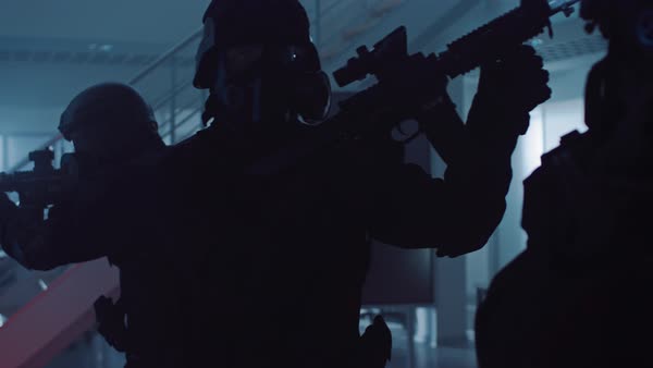 Close up portraits of masked squad of armed swat police officers storm ...