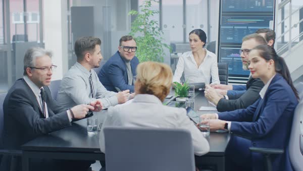 In the modern corporate office meeting room: diverse group of ...