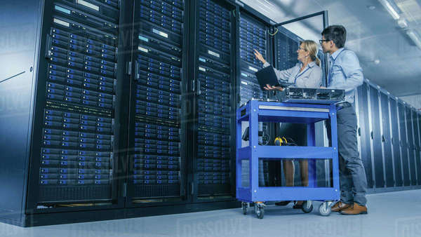 In the Modern Data Center: Engineer and IT Specialist Work with Server ...