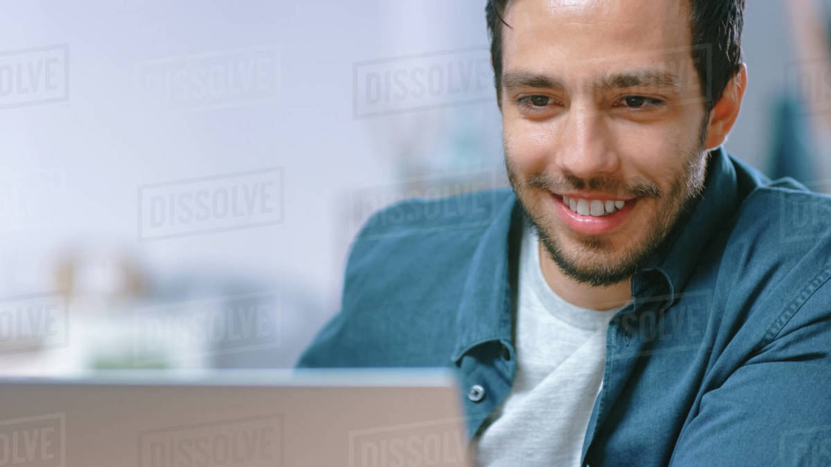 Portrait of a Handsome Young Man Using His Laptop Computer. His Sitting ...