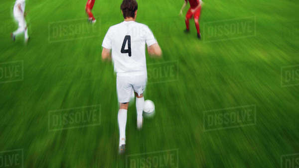 Blurred Motion Upper Follow Shot of Professional Soccer Player Leads ...