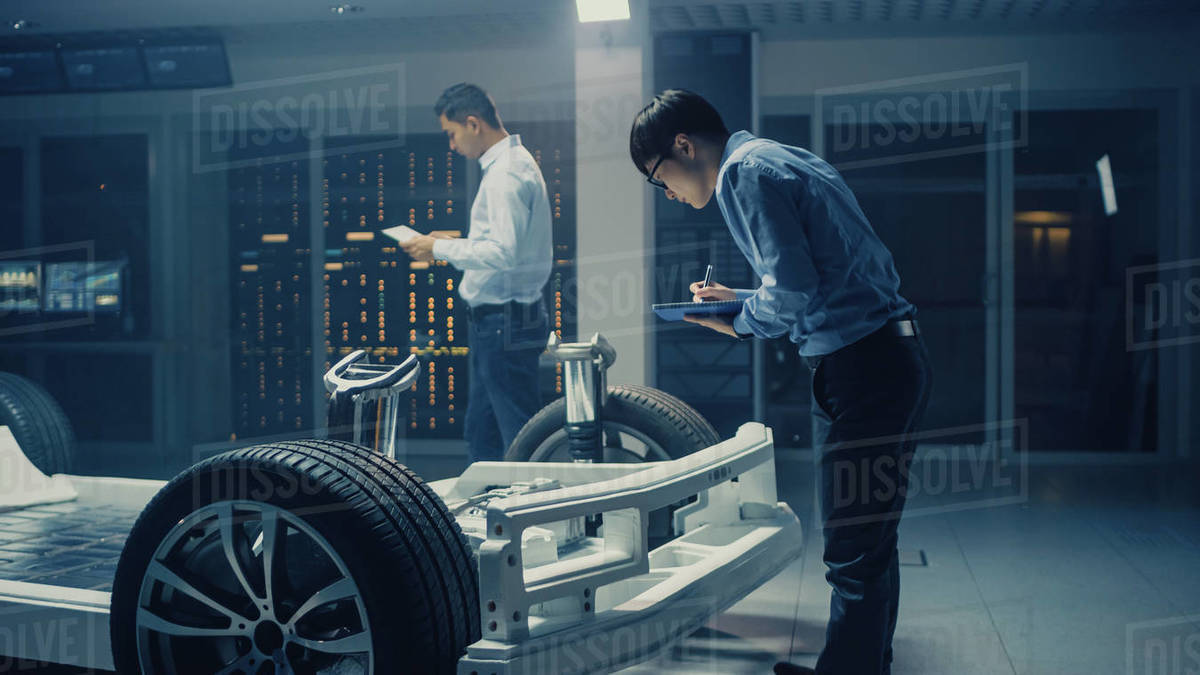 Automotive Engineers Working on Electric Car Chassis Platform, Taking ...