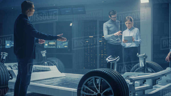 Automobile Engineers Discussing and Designing Electric Car Chassis ...
