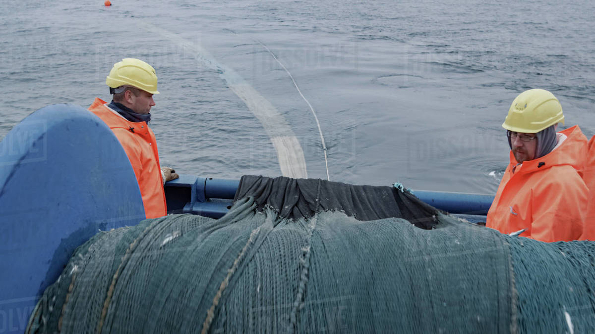 Team of Fishermen Unwind the Trawl Net During Commercial Fishing ...