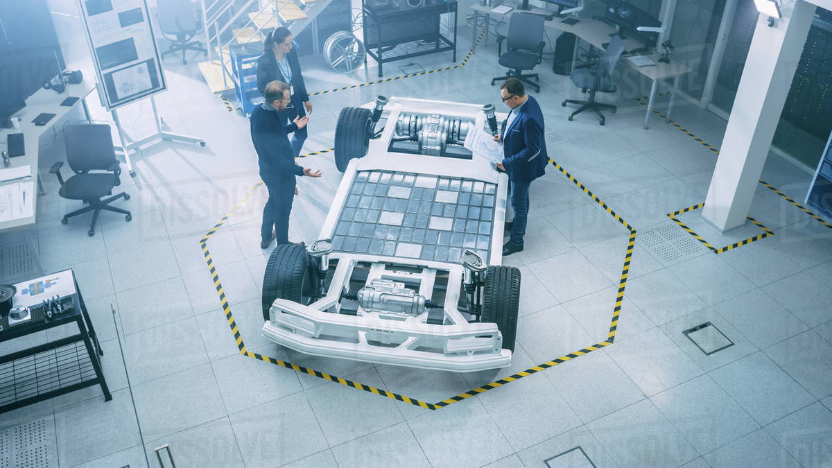 Automotive Design Engineers Talking while Working on Electric Car ...