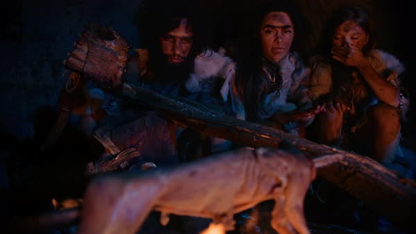 Neanderthal or Homo Sapiens Family Cooking Animal Meat over Bonfire and ...