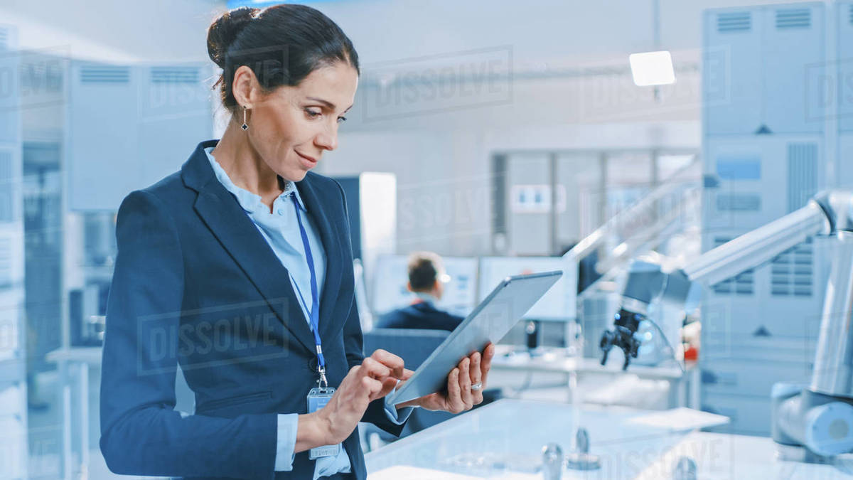 Stylish Female Industrial Robotics Engineer Uses Tablet Computer to ...